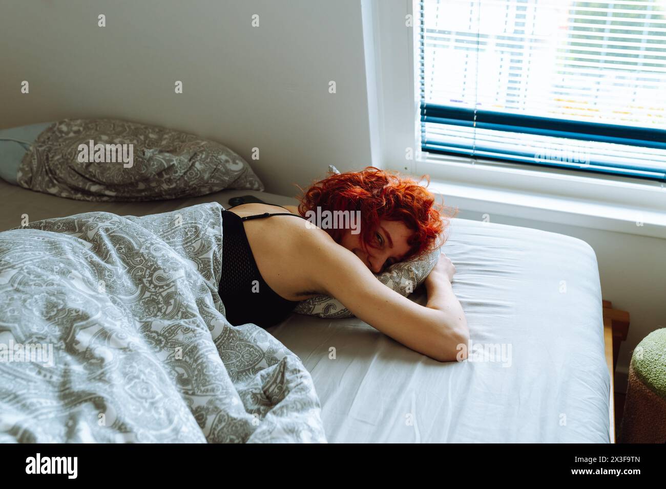 morning, young woman waking up in bed with natural hair under arms ...