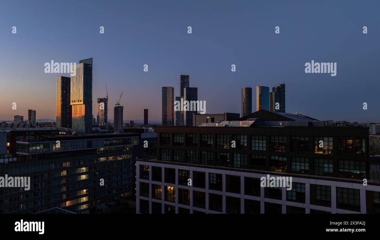 A serene twilight view over a cityscape showcasing glowing skyscraper ...