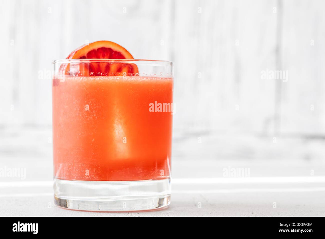 Sicilian Negroni cocktail garnished with orange wheel Stock Photo - Alamy