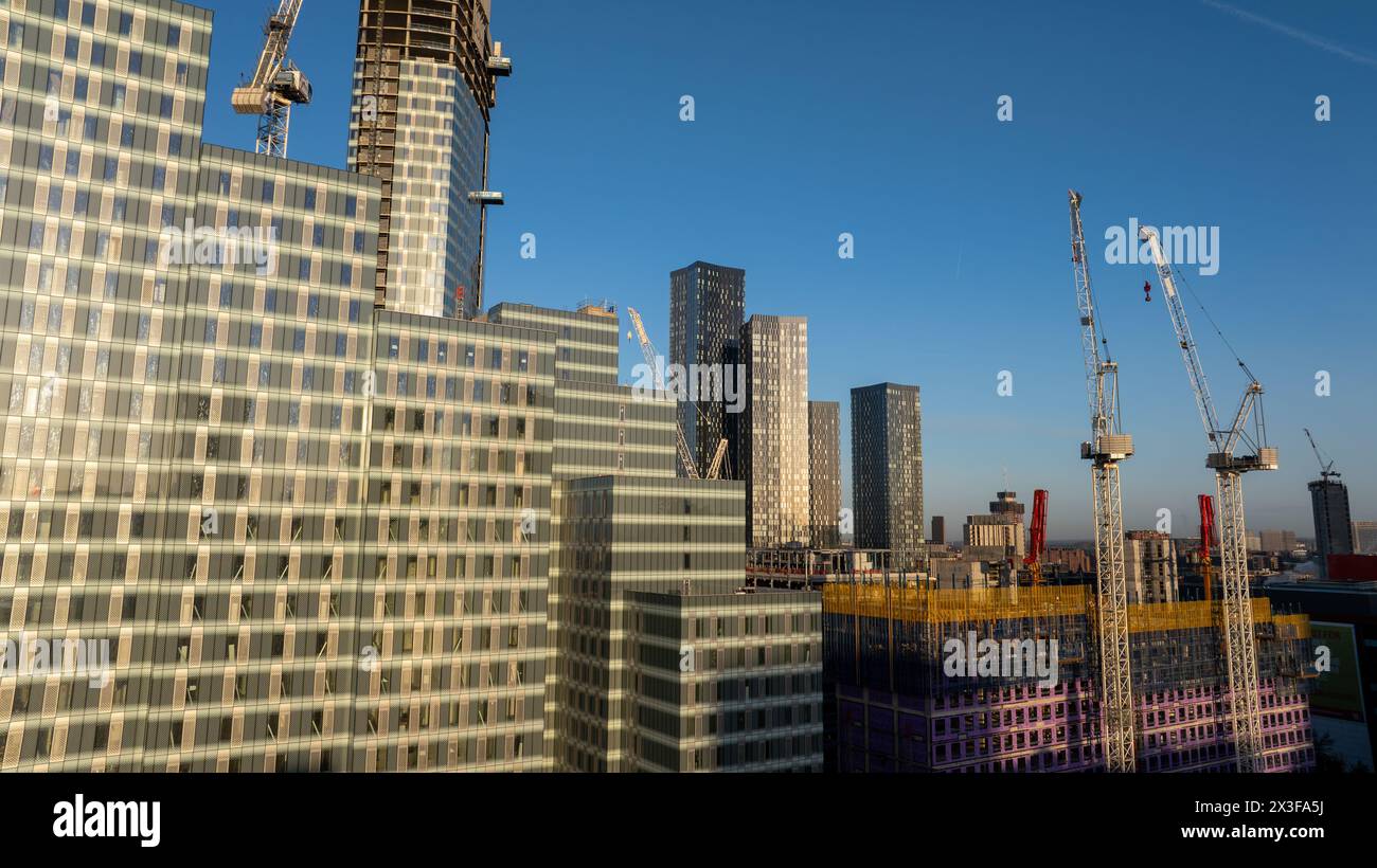 A dynamic city construction site with tall glass skyscrapers and ...