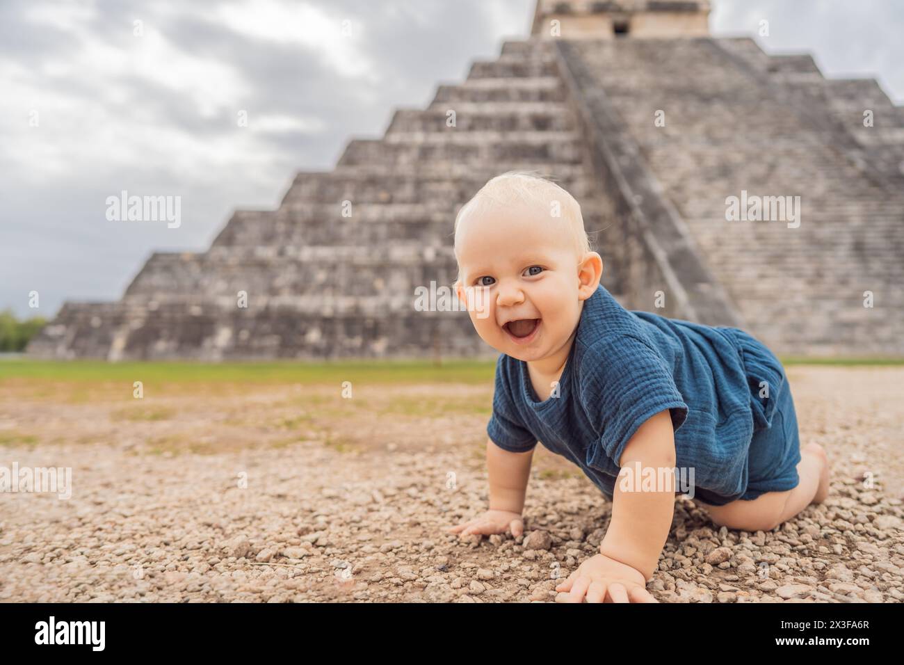 Baby traveler, tourists observing the old pyramid and temple of the ...