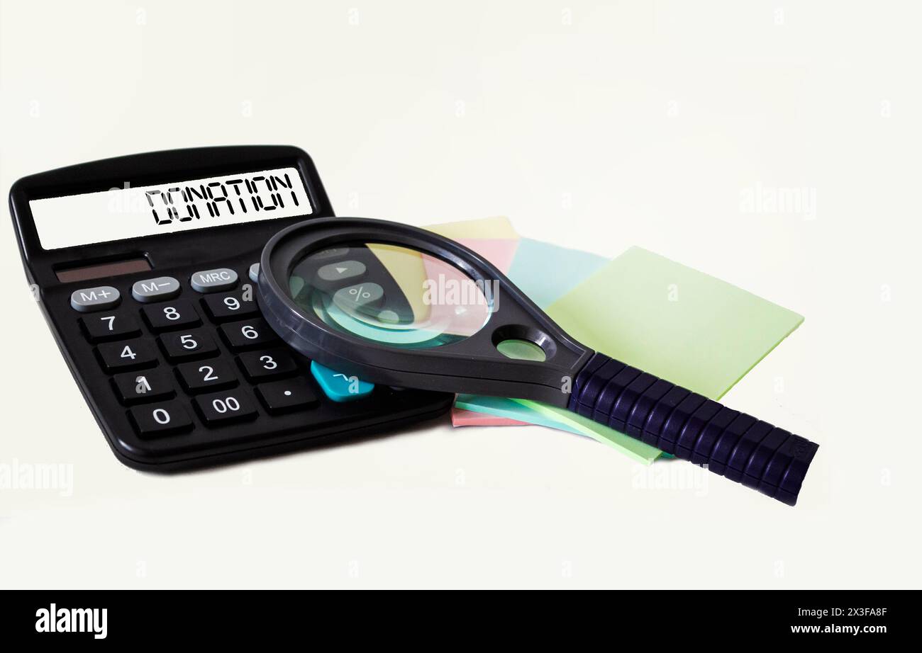 Donation word on calculator display and white background with stickers ...