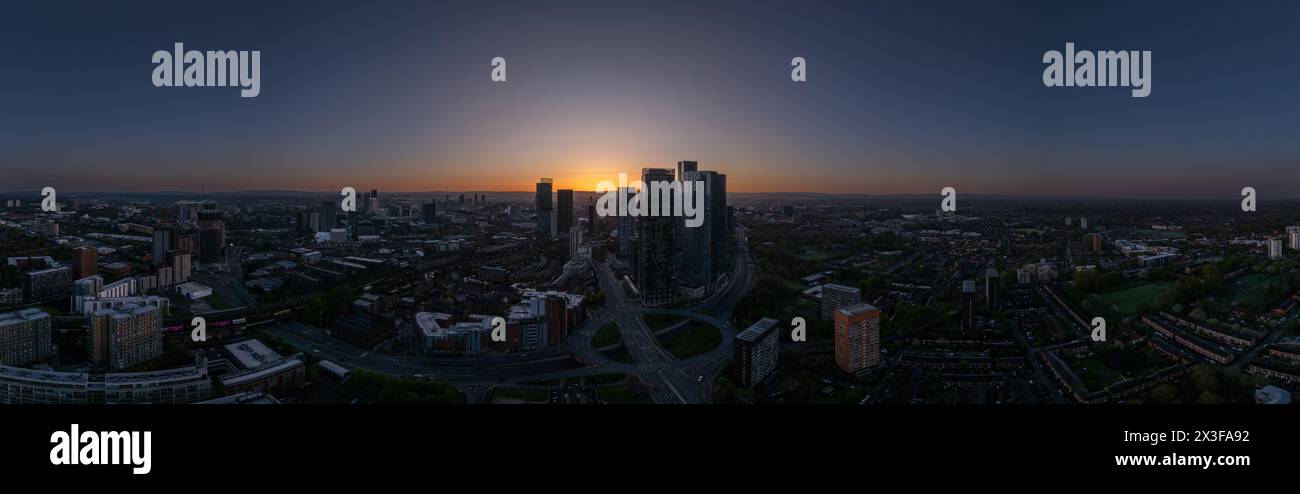 The panoramic image captures a striking sunset descending behind ...