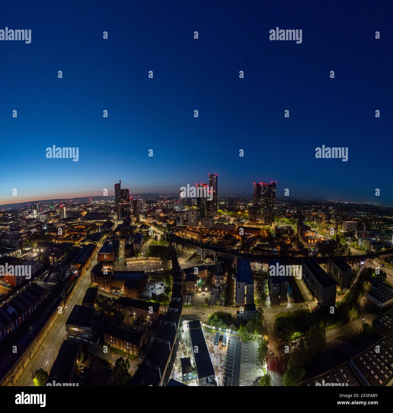 This aerial view showcases a city's skyline at twilight with buildings ...