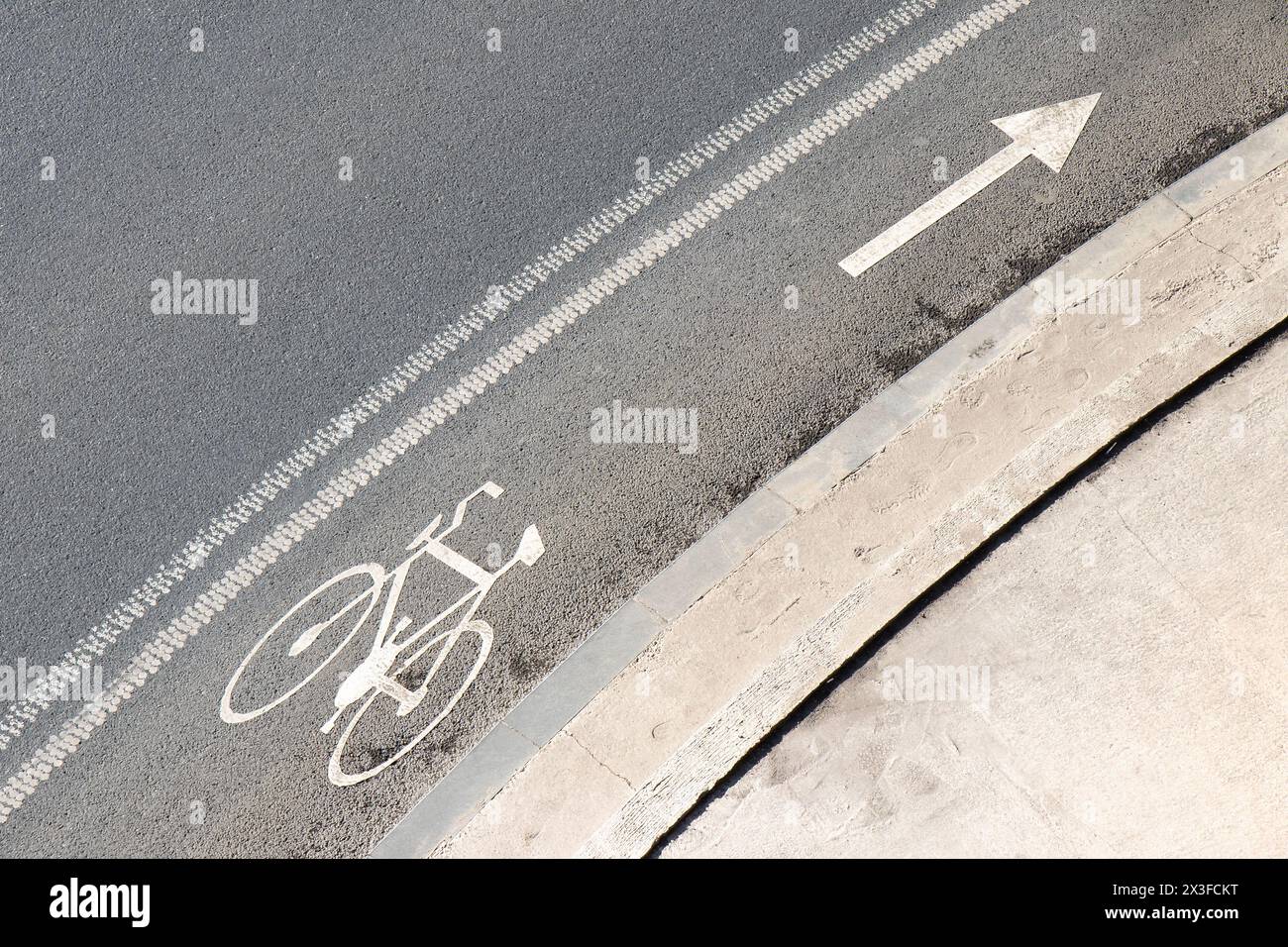 Road markings with arrow and bike symbol on city street bike lane and ...
