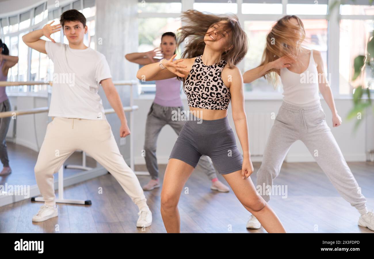 Young girl practicing hip-hop dance in training hall in group Stock ...