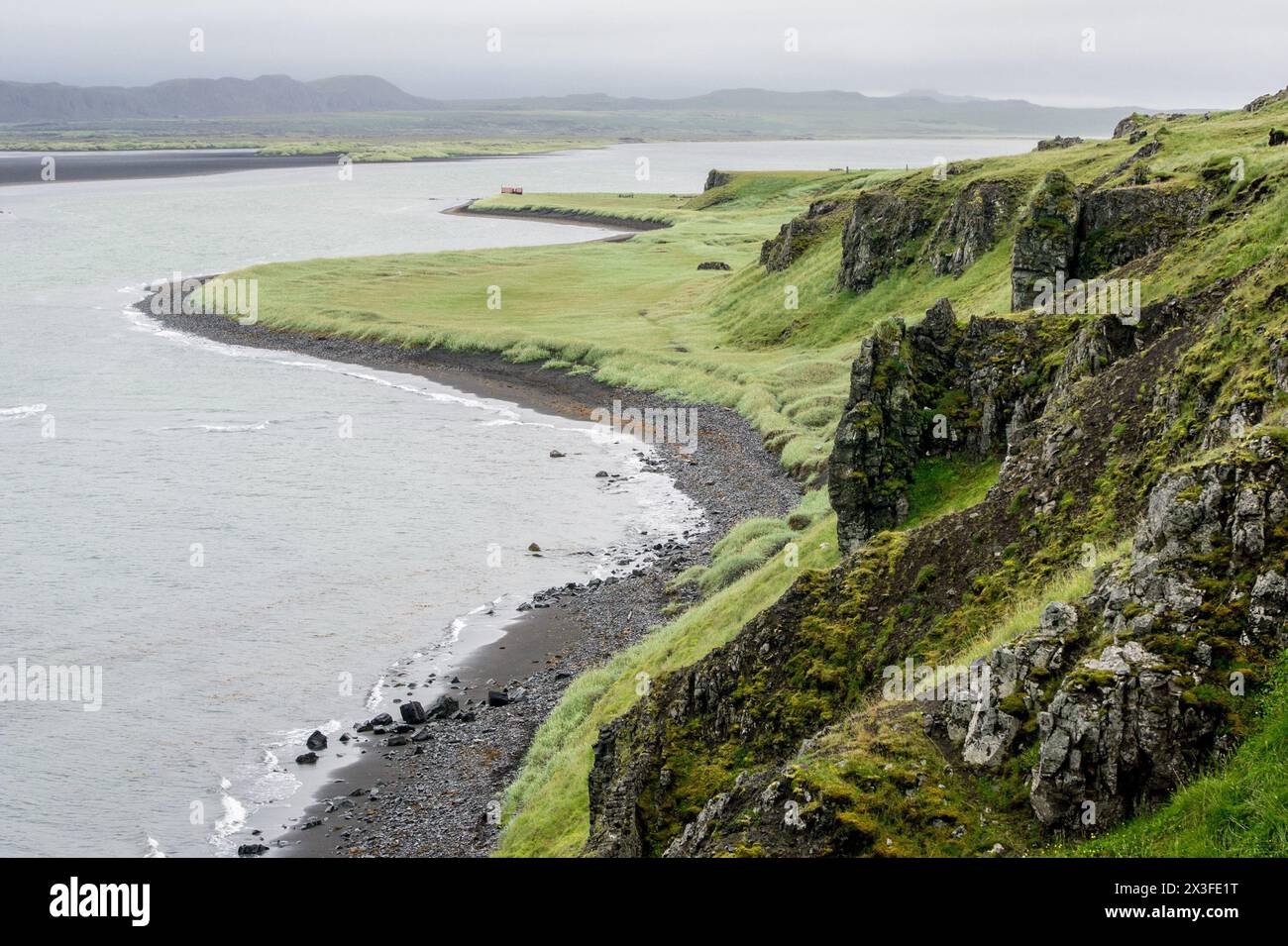 Icelandic shore near the Hvitserkur rock with a lot of rocks and grass ...