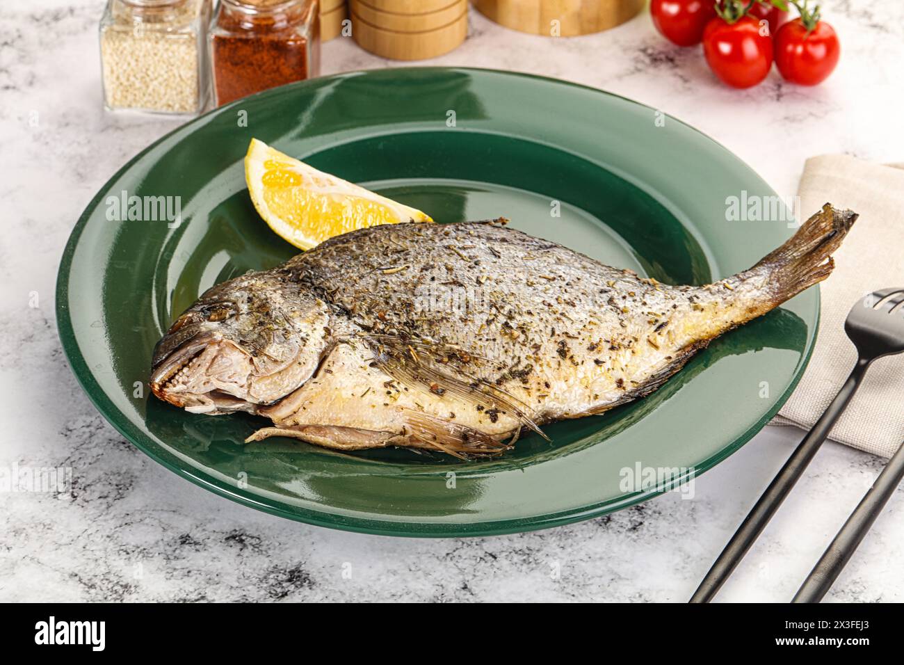 Baked Dorado fish served lemon slice Stock Photo - Alamy