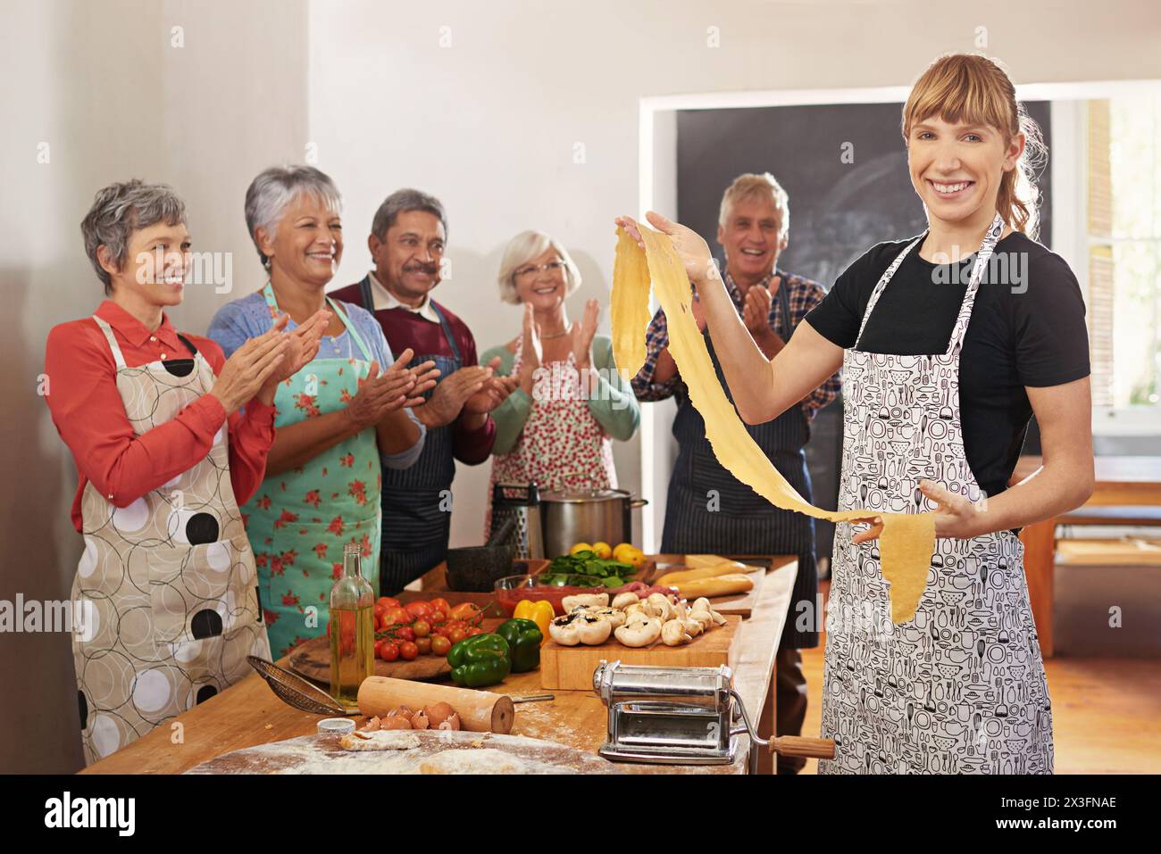 Cooking, pasta and portrait of people in kitchen learning recipe for ...