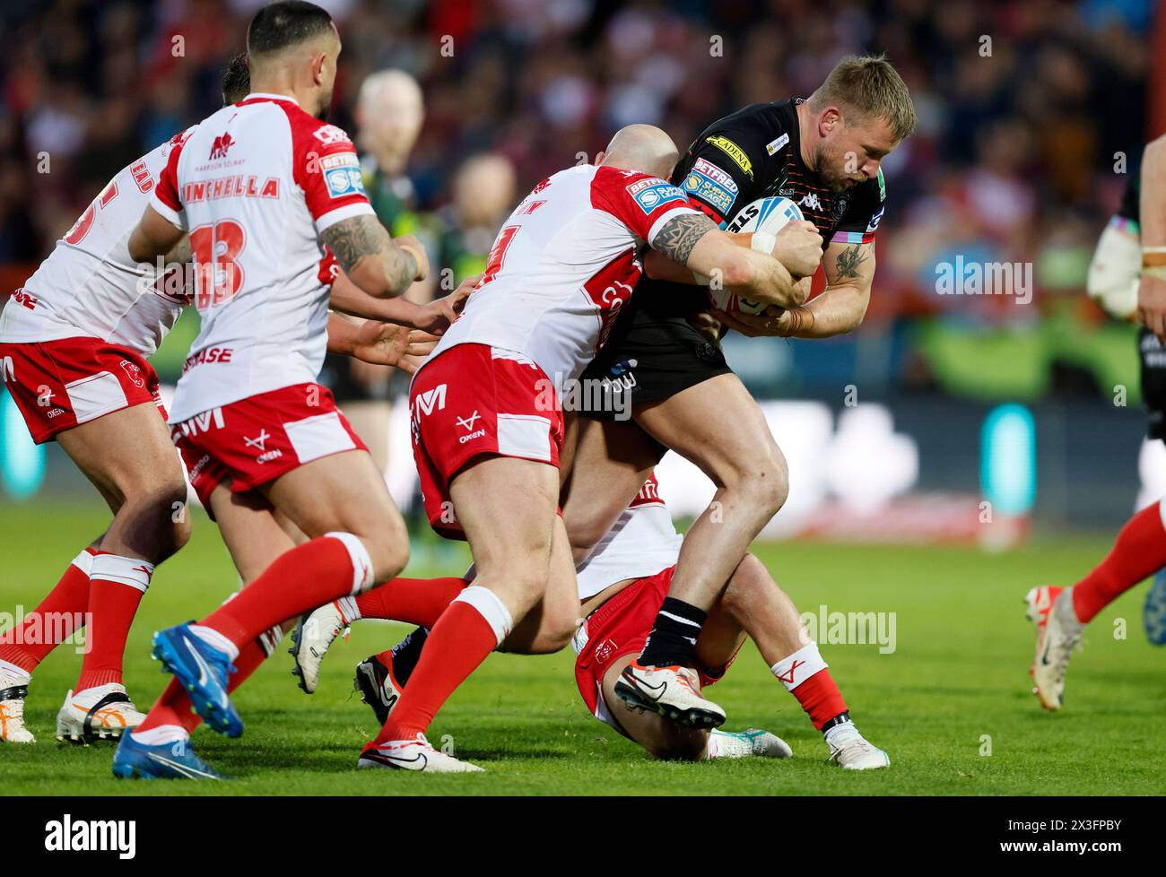 Wigan Warriors' Mike Cooper (right) is tackled by Hull Kingston Rovers ...