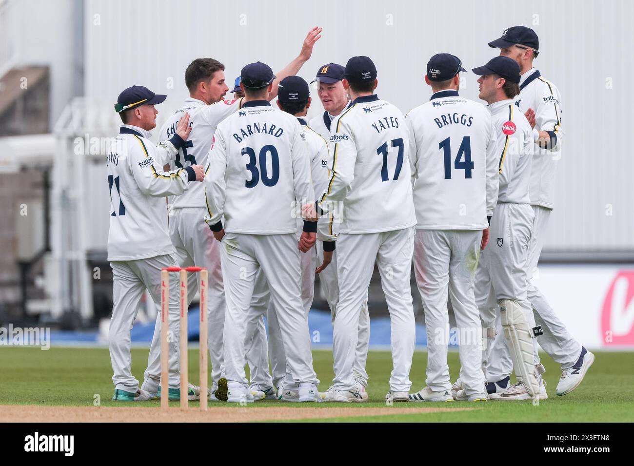 Pictured is Will Rhodes of Warwickshire raising his hand to high five a ...