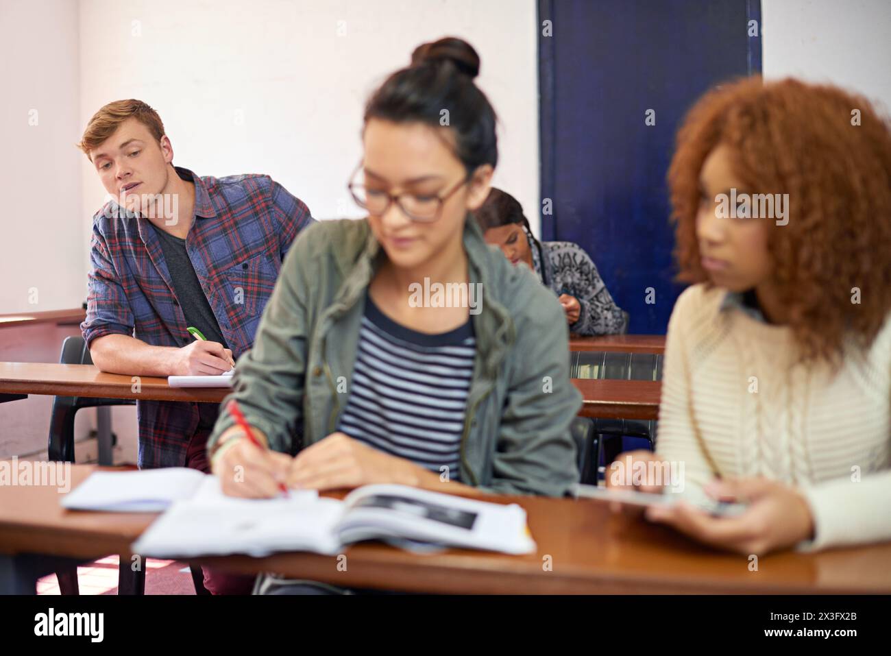 College student, man and copying test in classroom with reading ...