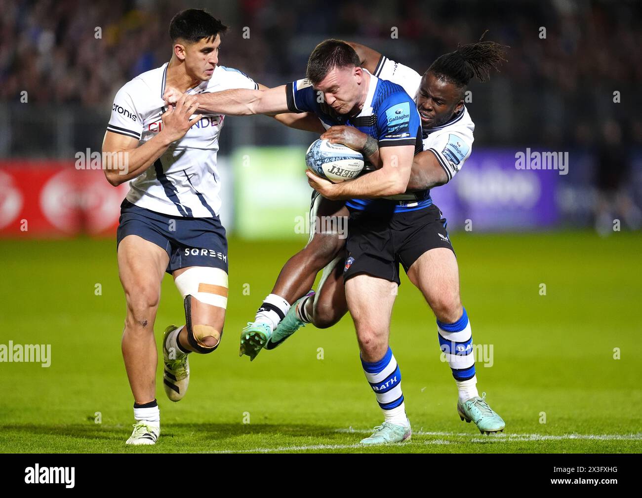 Bath Rugby's Matt Gallagher (centre) is tackled by Saracens' Lucio ...
