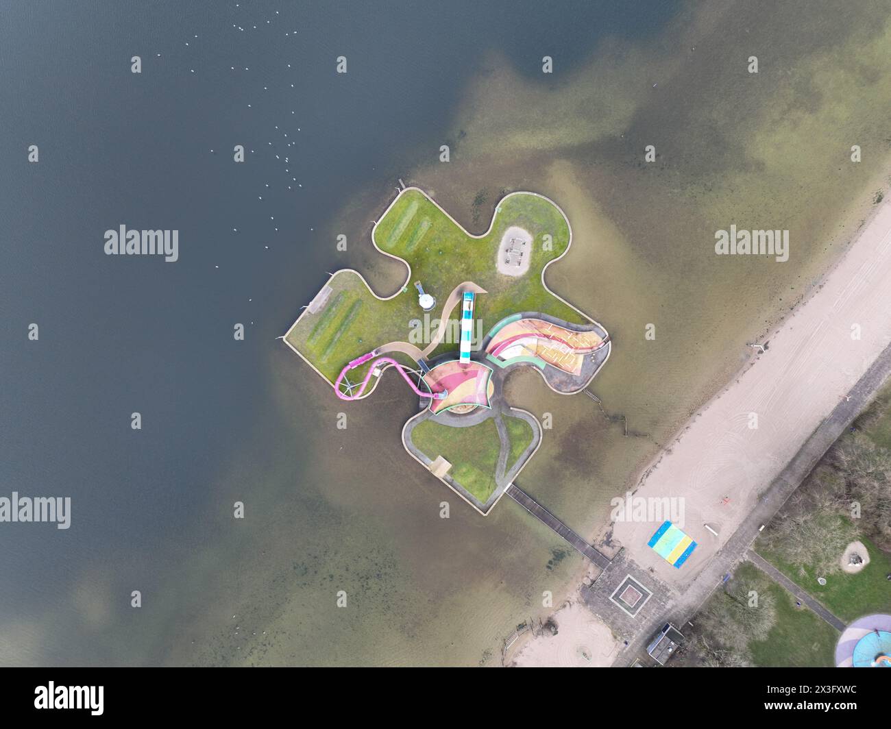 Aerial drone view children playground in the form of a puzzle piece ...