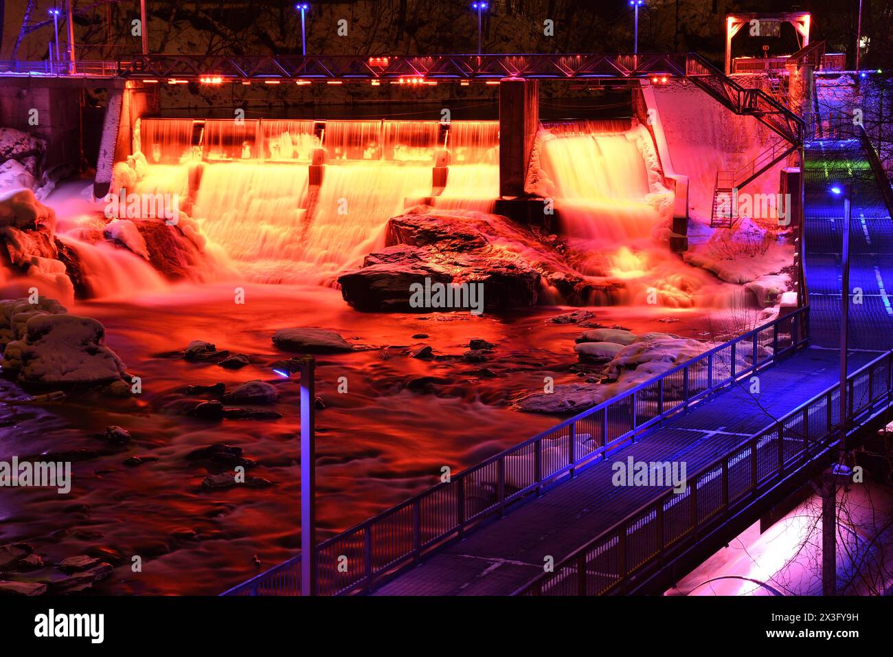 Sherbrooke Magog River downtown at night. Red illuminated power dam ...