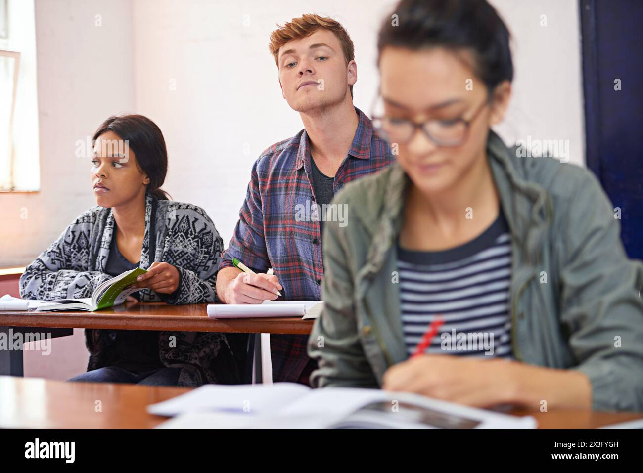 University student, man and copying test in classroom with reading ...