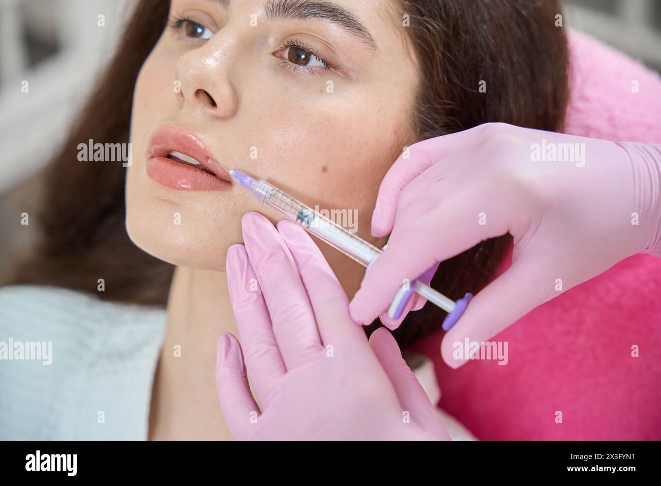 Dermatologist giving beauty injection to woman during facial aesthetic ...