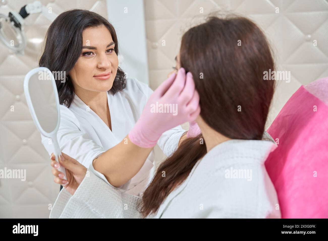 Adult woman undergoing dermatological examination during initial ...