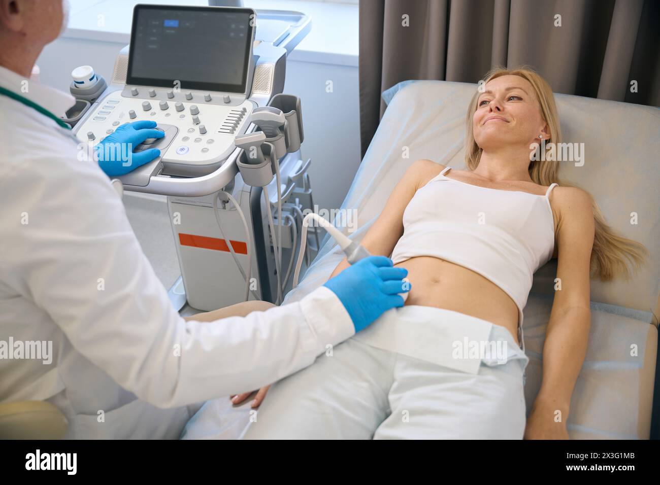 Top view of woman getting ultrasound scan by doctor Stock Photo - Alamy