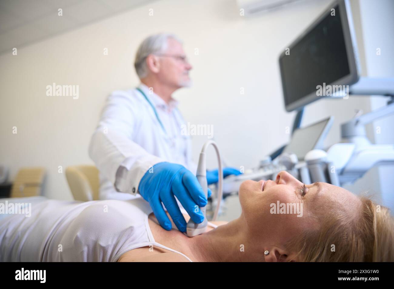 Woman getting thyroid ultrasound exam in hospital Stock Photo - Alamy