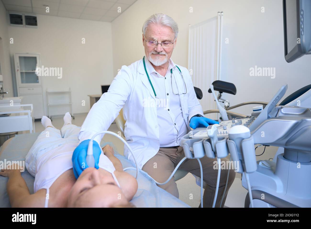Female getting thyroid ultrasound exam at clinic Stock Photo - Alamy