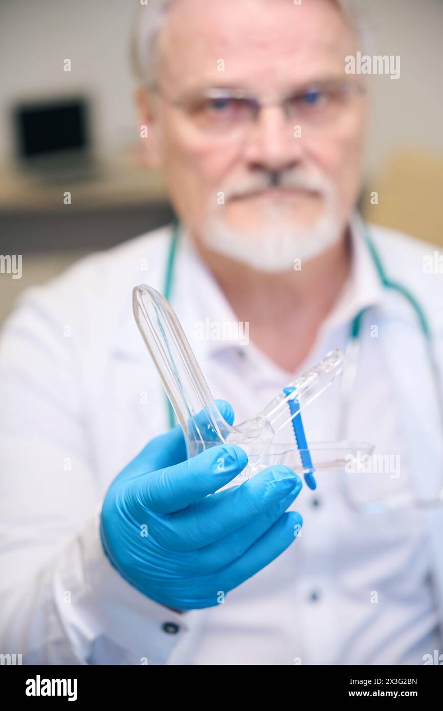 Male medic holding medical instrument in hospital Stock Photo - Alamy