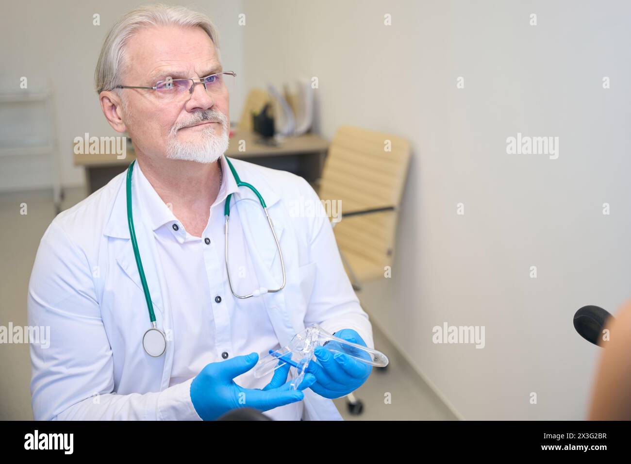 Professional medic holding medical instrument in hospital Stock Photo ...