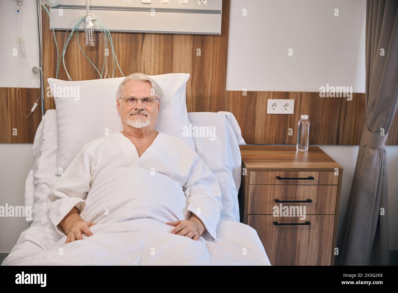 Hospitalized mature man lying in hospital bed Stock Photo - Alamy