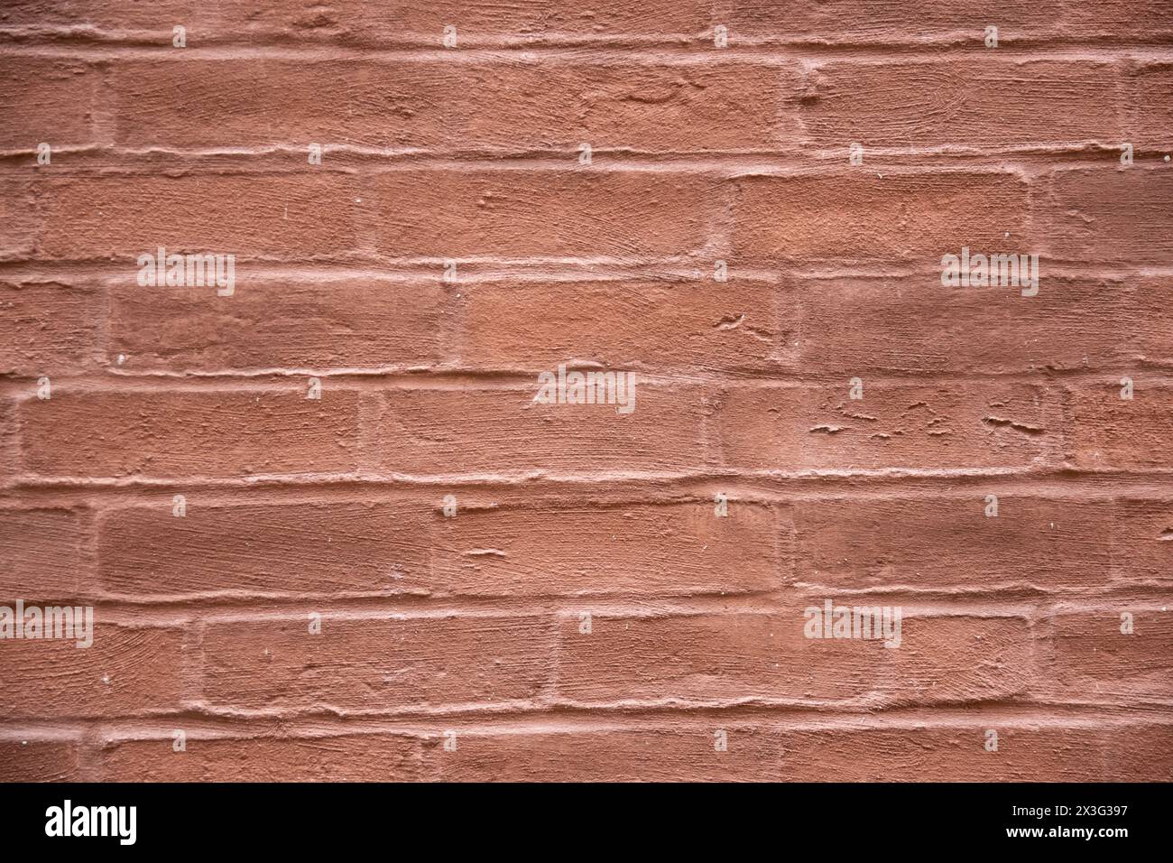 Red structural stone wall of building consists of old little bricks ...