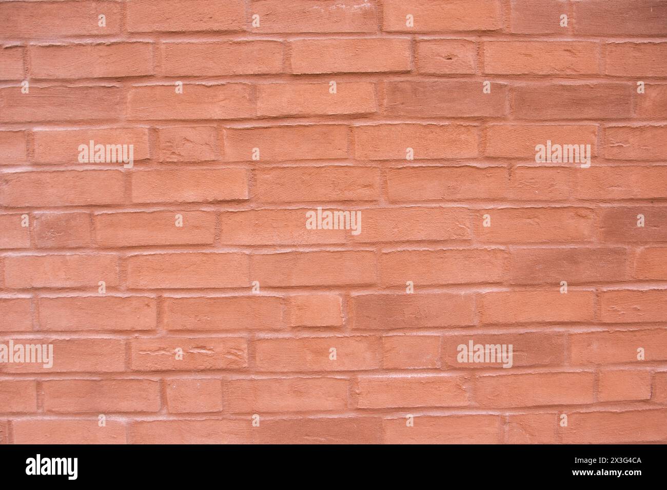 Structural stone wall of the modern building consists of red little ...