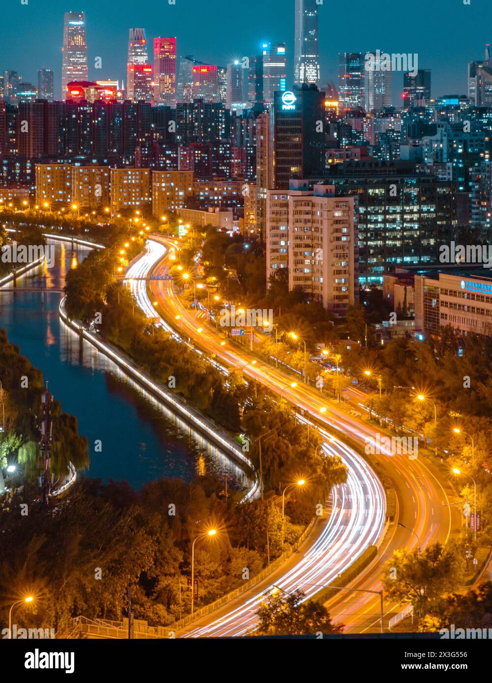 Aerial view of a traffic flow with the backdrop of Guomao CBD at night ...