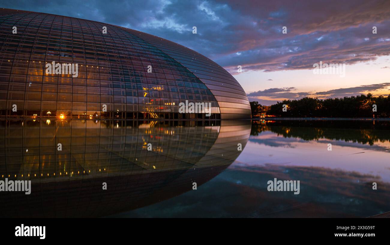 the national centre hall with fire clouds and reflection in Beijing ...