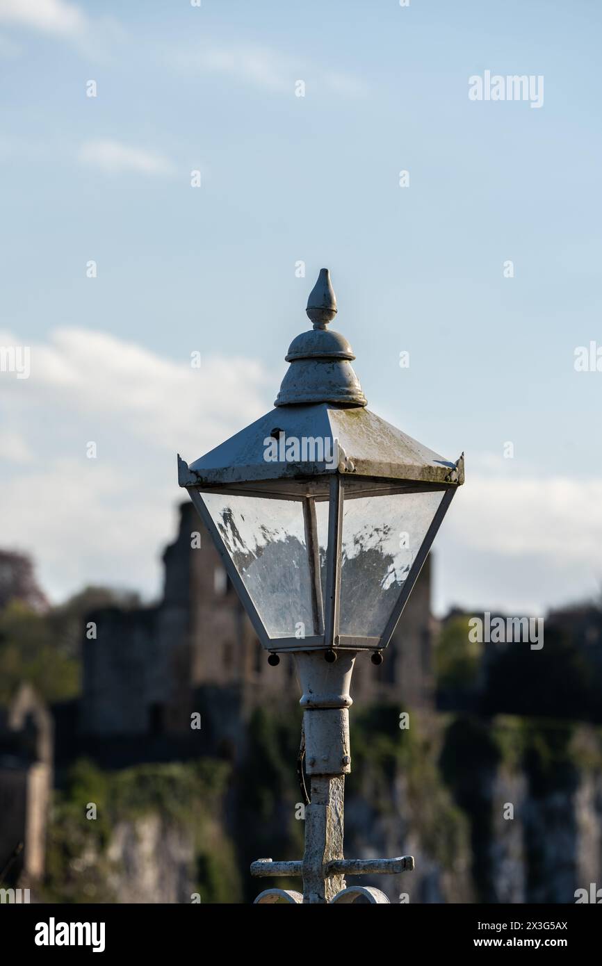 Old-fashioned lantern with a blurred castle backdrop under a clear sky ...
