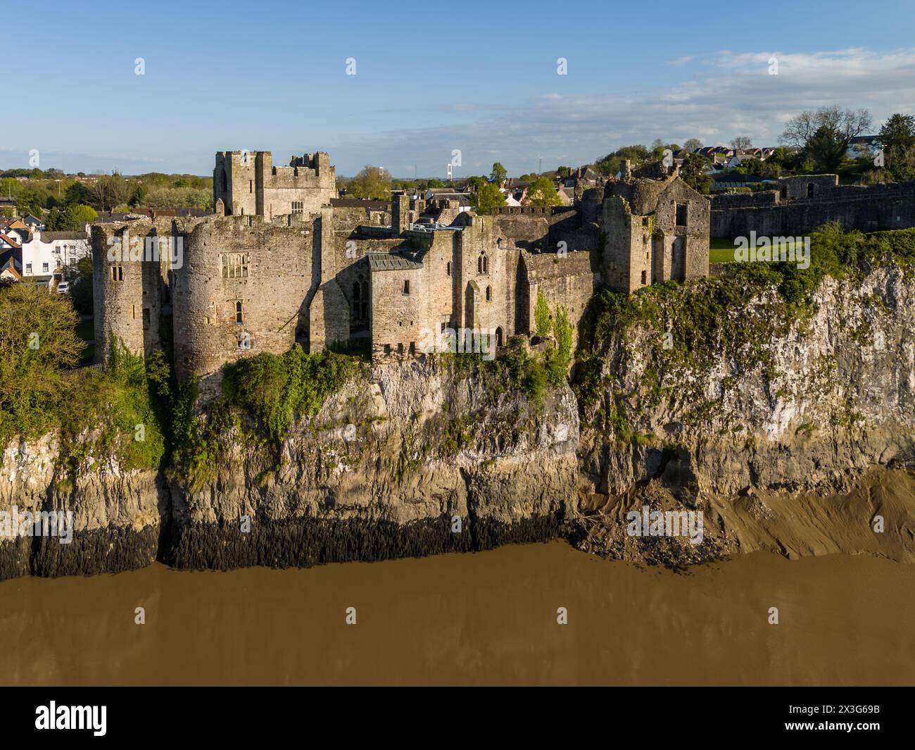 Aerial shot captures a majestic medieval castle perched atop a rugged ...
