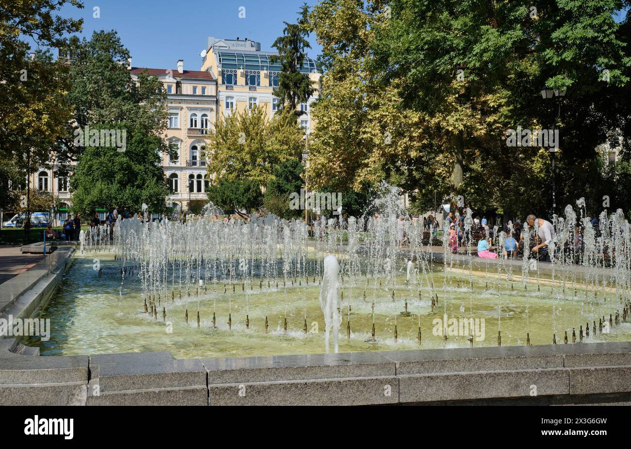 Bulgaria, Sofia; 22 September 2023, people relax by the fountain in the ...