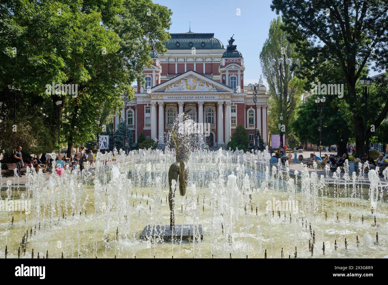 Bulgaria, Sofia; people relax by the fountain in the Gradska Gradina ...