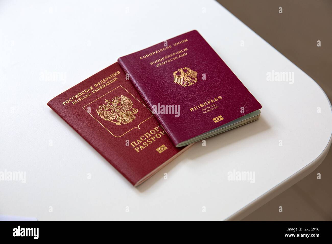 Close up of a German and a Russian passport on white table Stock Photo ...