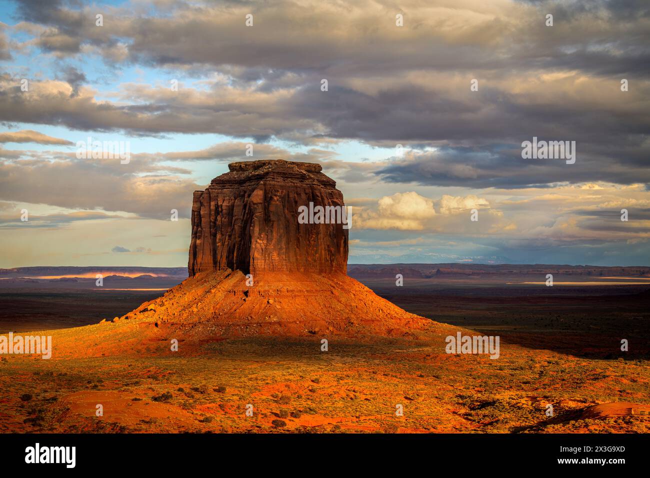 Low rainclouds during sunset hug a butte in Monument Valley's Navajo ...