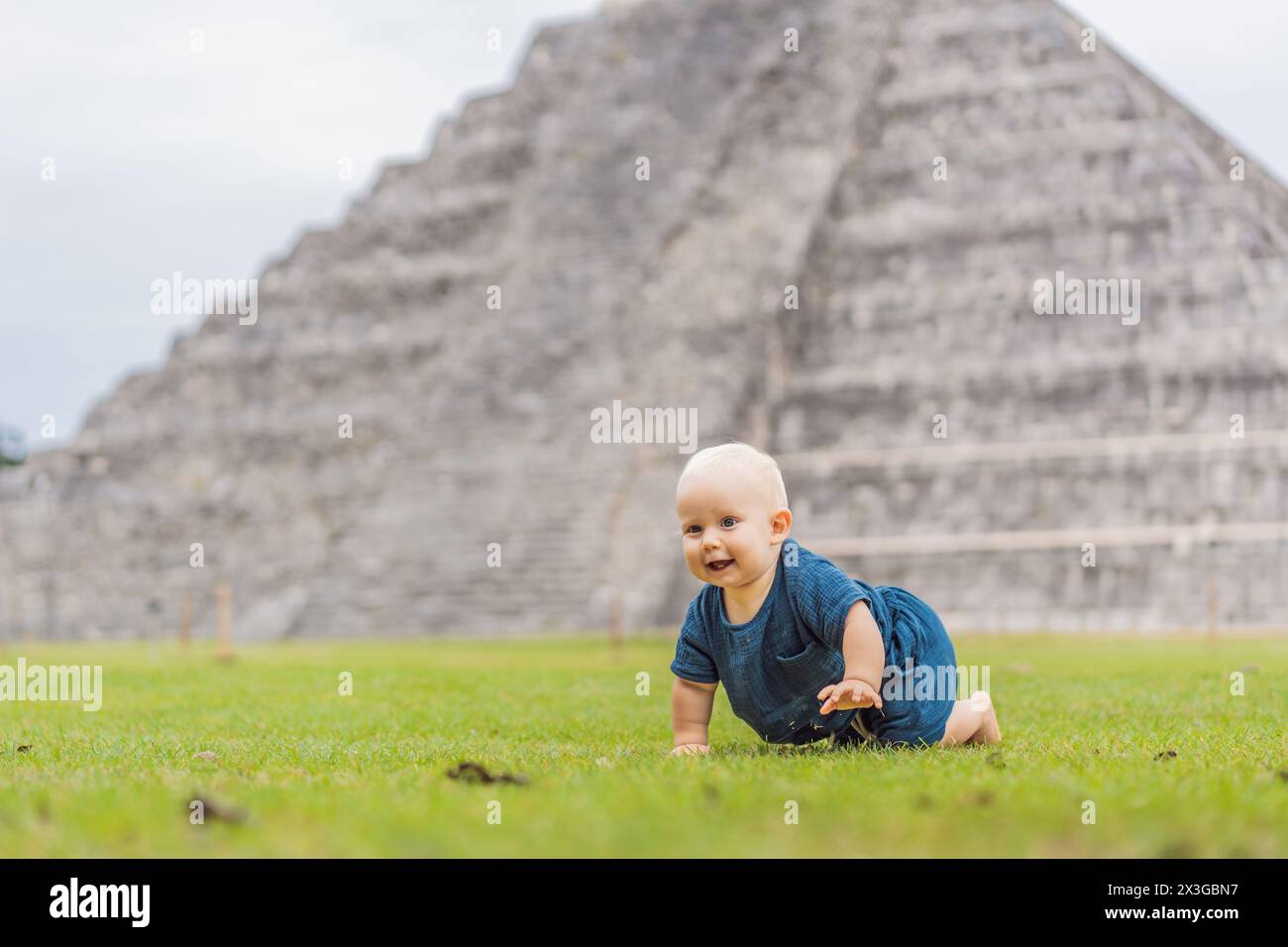 Baby traveler, tourists observing the old pyramid and temple of the ...