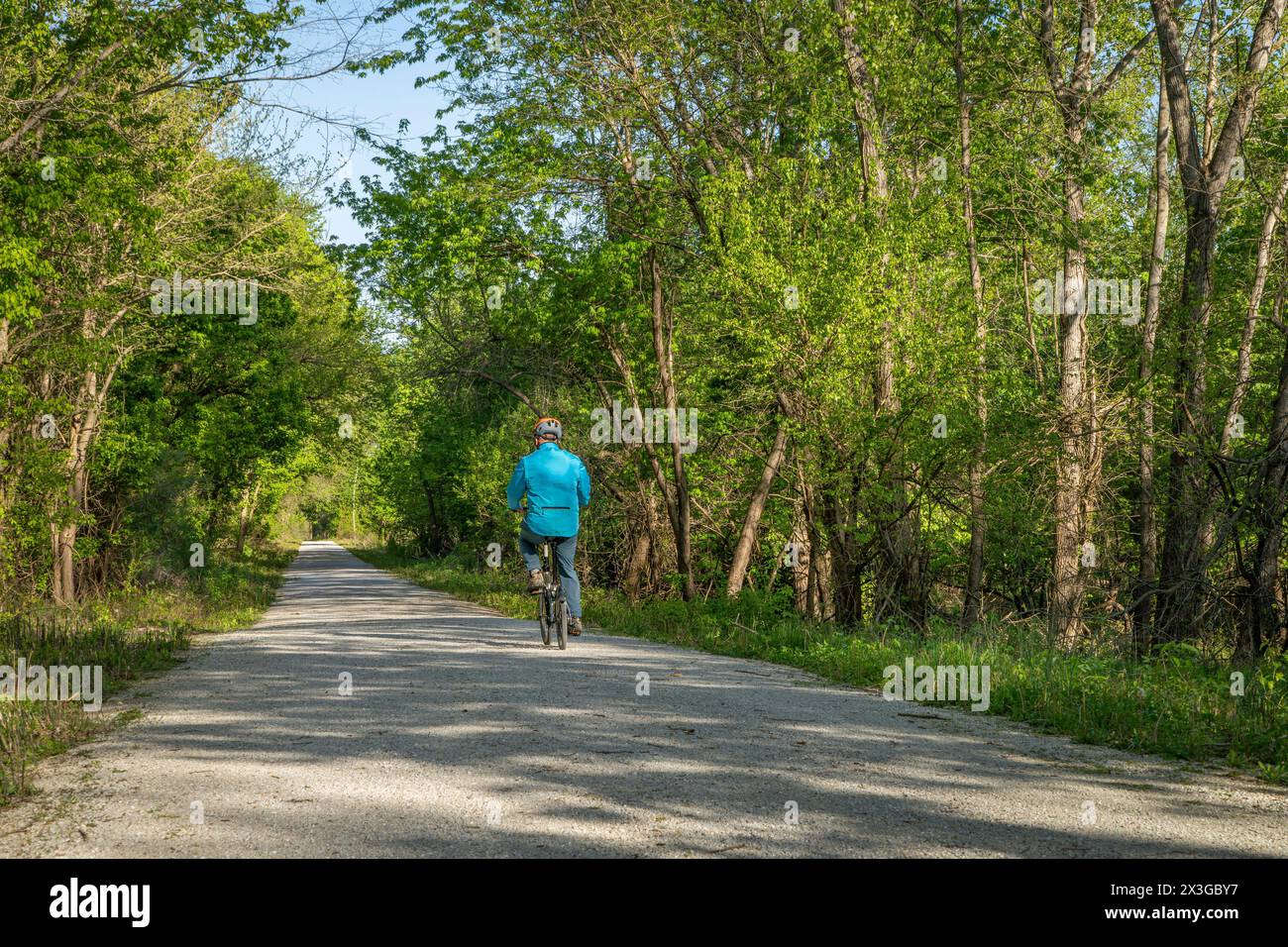 Male cyclist is riding a folding bike on Katy Trail near Rocheport ...