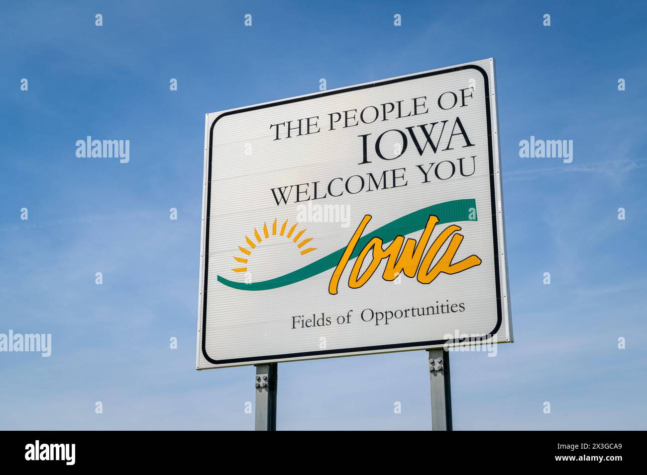 Iowa welcome roadside sign against blue sky at state border with ...