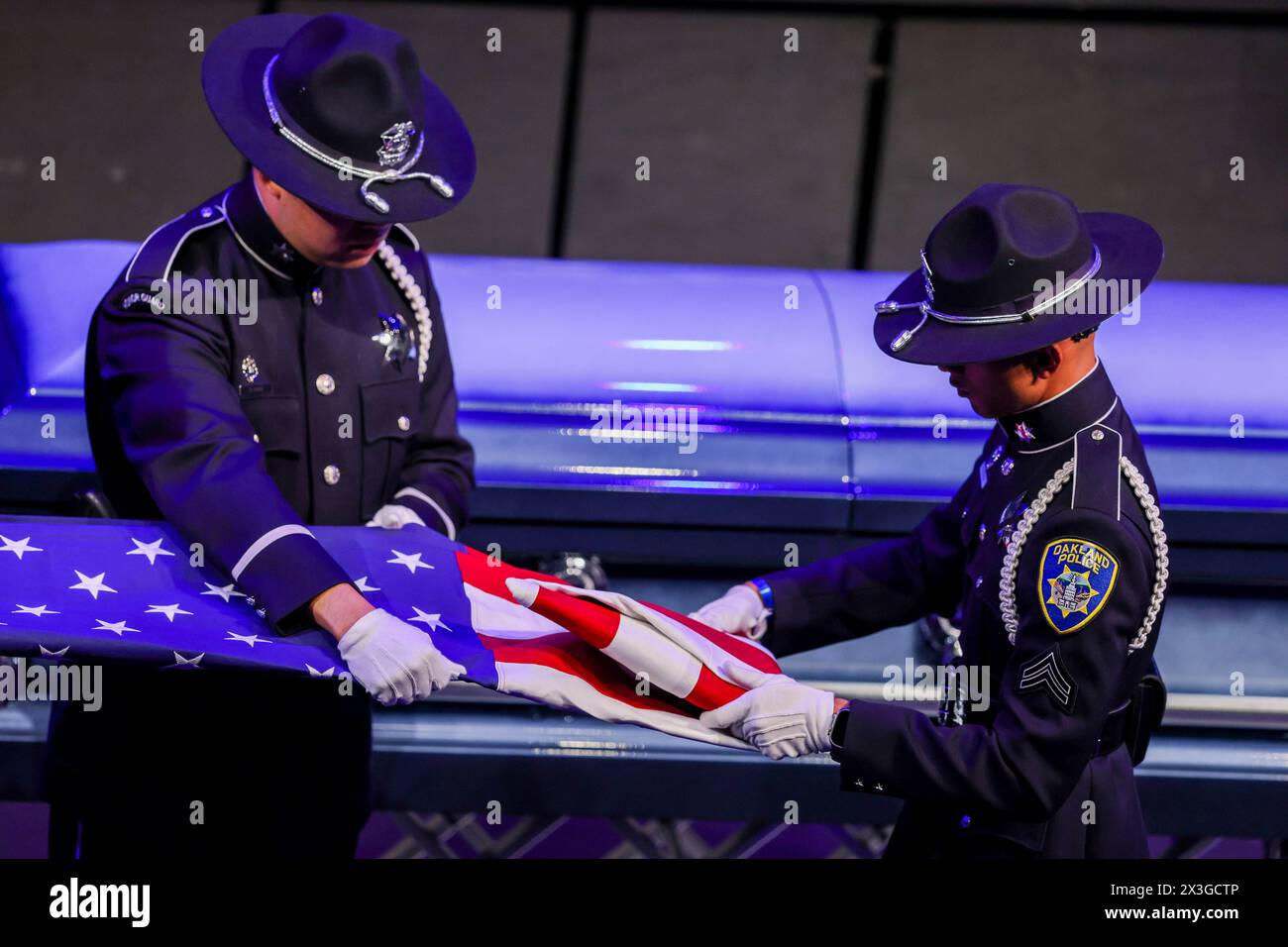 Oakland Police Honor Guard remove and fold the American flag from the ...