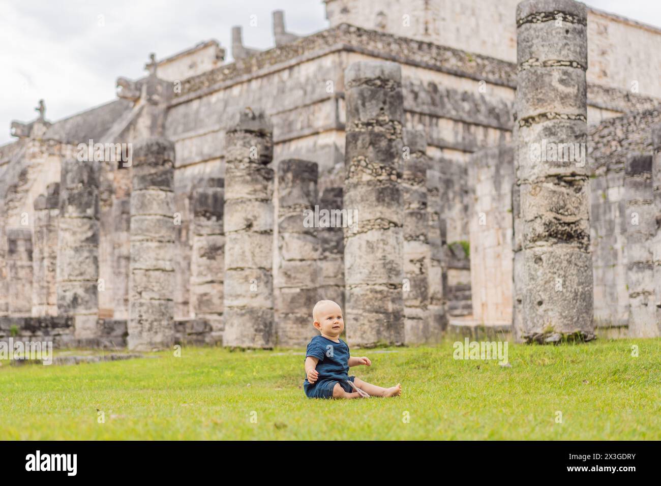 Baby traveler, tourists observing the old pyramid and temple of the ...