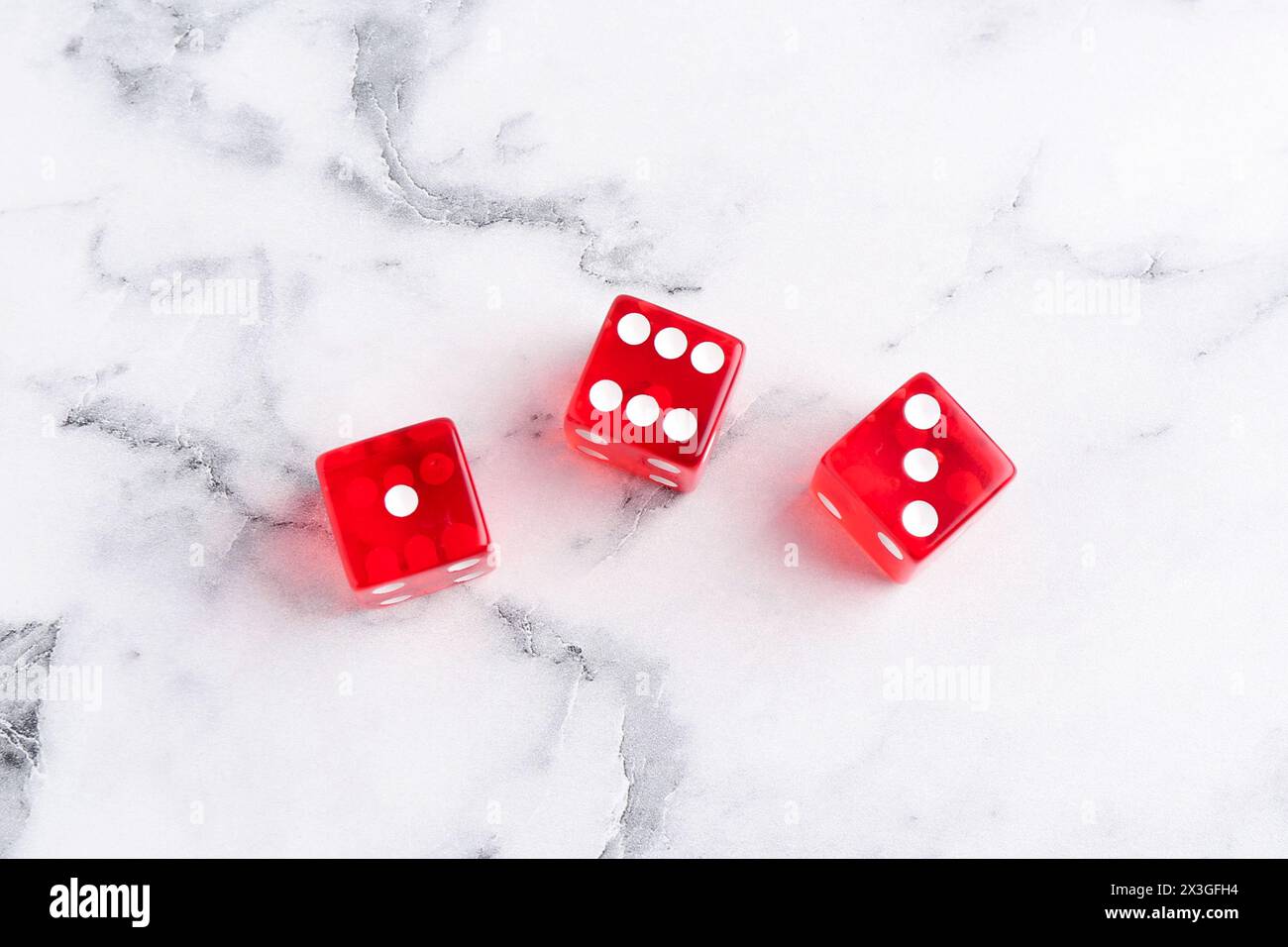 Three red game dices on white marble table, flat lay Stock Photo - Alamy