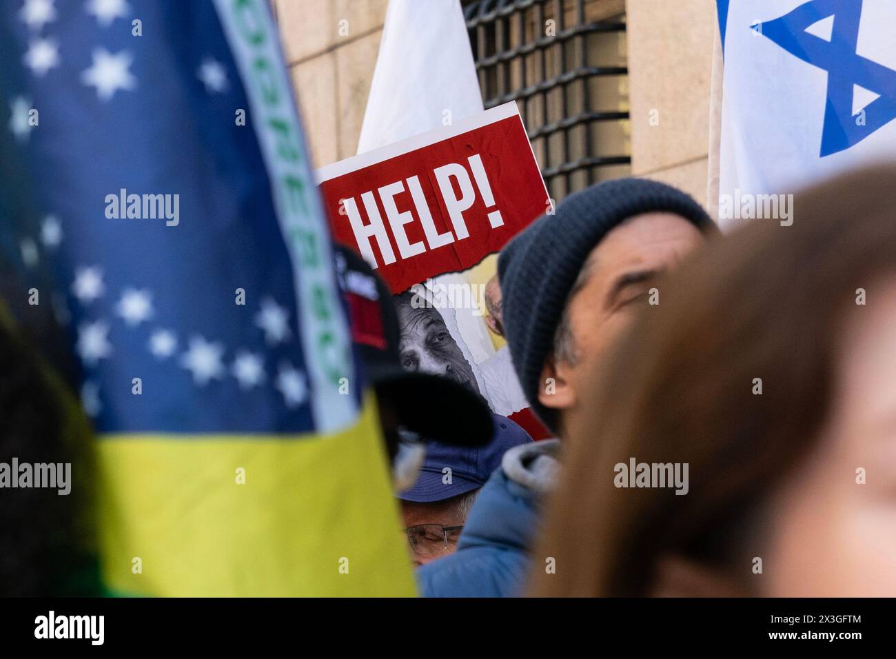 A person holds 'HELP' poster with photo of hostage at the "Bring Them ...