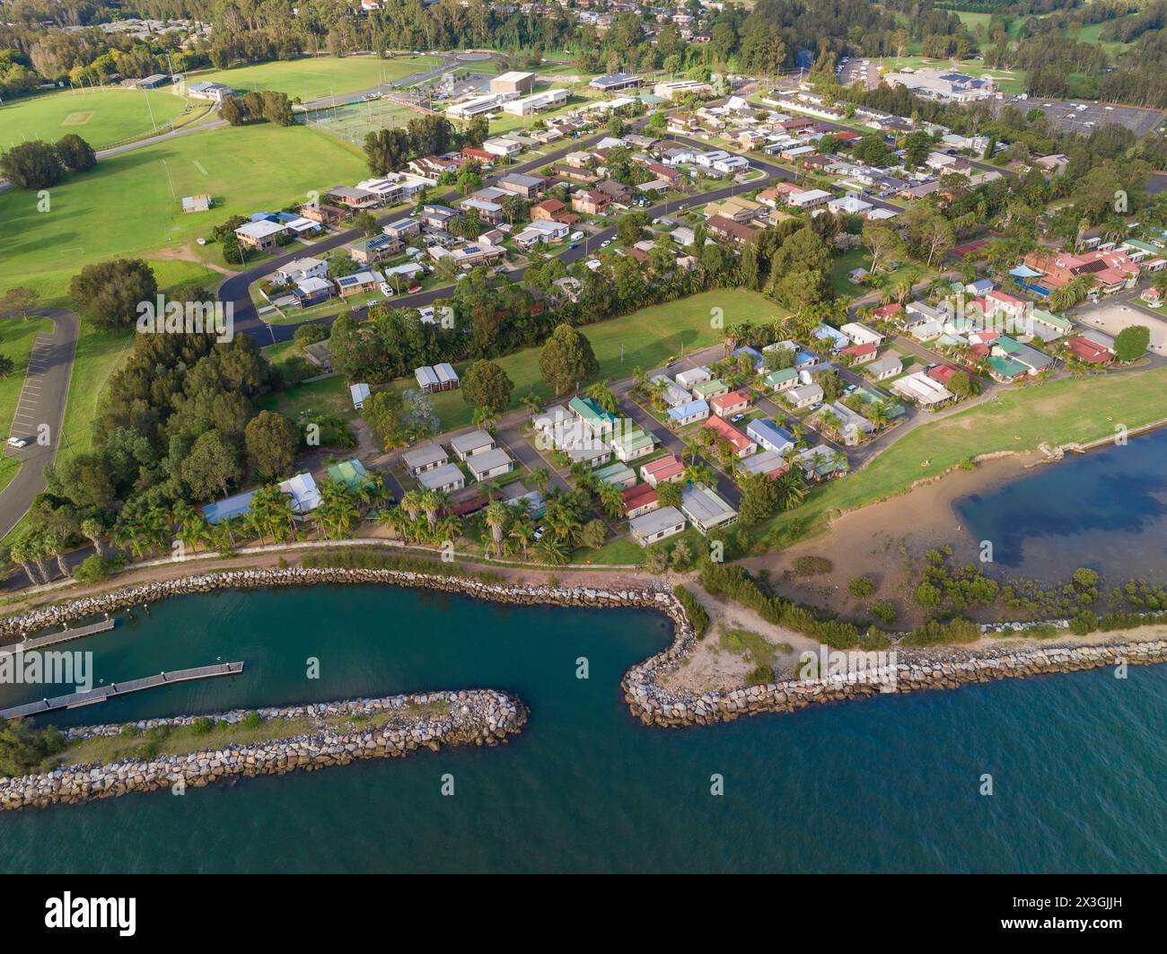 Aerial view of a housing development alongside a coastline and ...