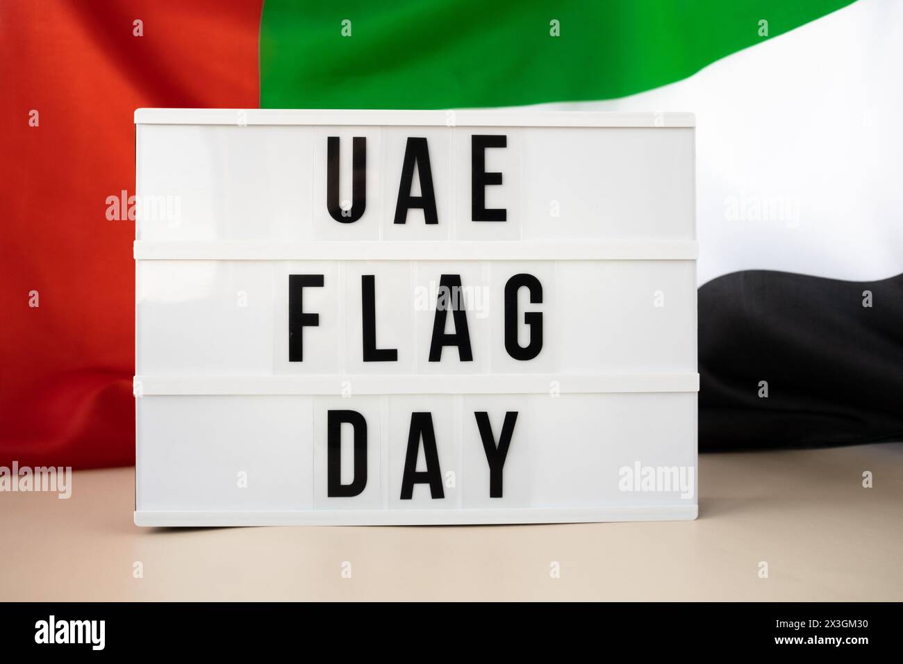 Lightbox with text UAE FLAG DAY on United Arab Emirates waving flag ...
