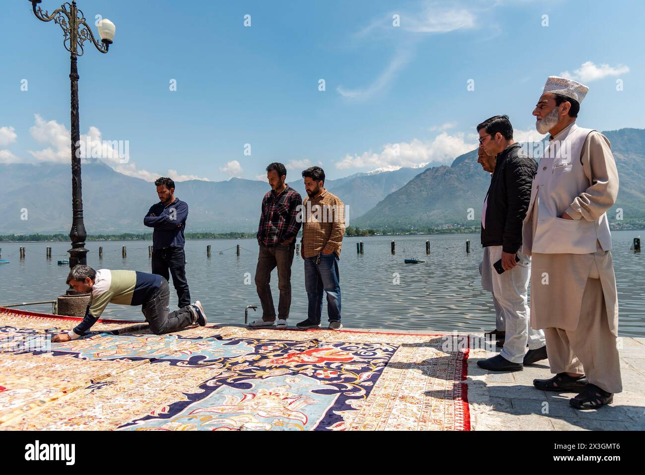 People watch the workers seen removing dust and threads from the ...