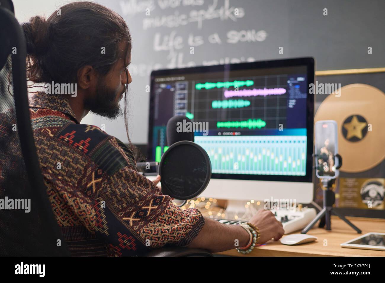 Focus on young Indian man looking at computer screen with frequency ...