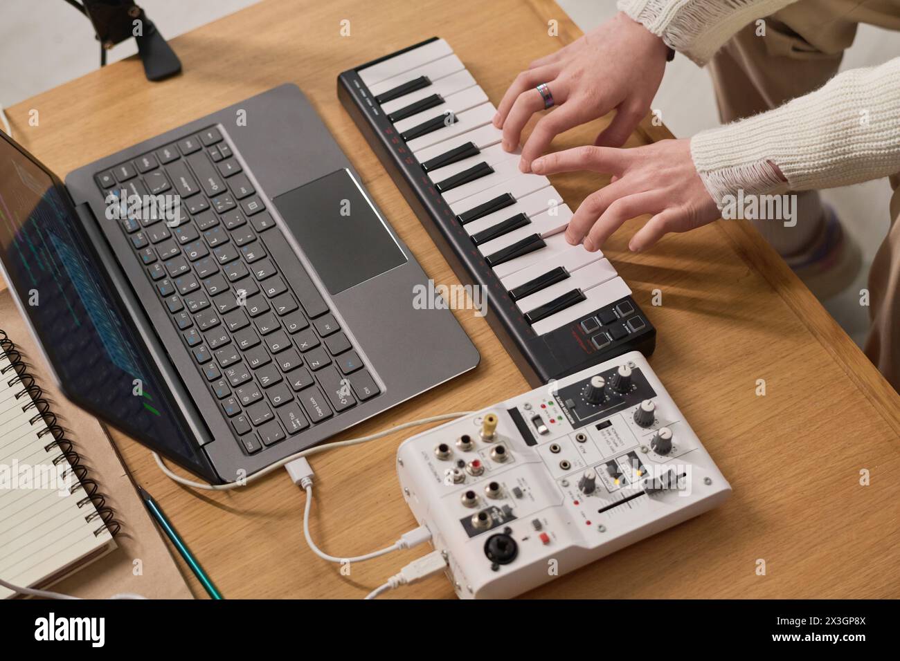 High angle shot of female hands over keys of electric piano creating ...